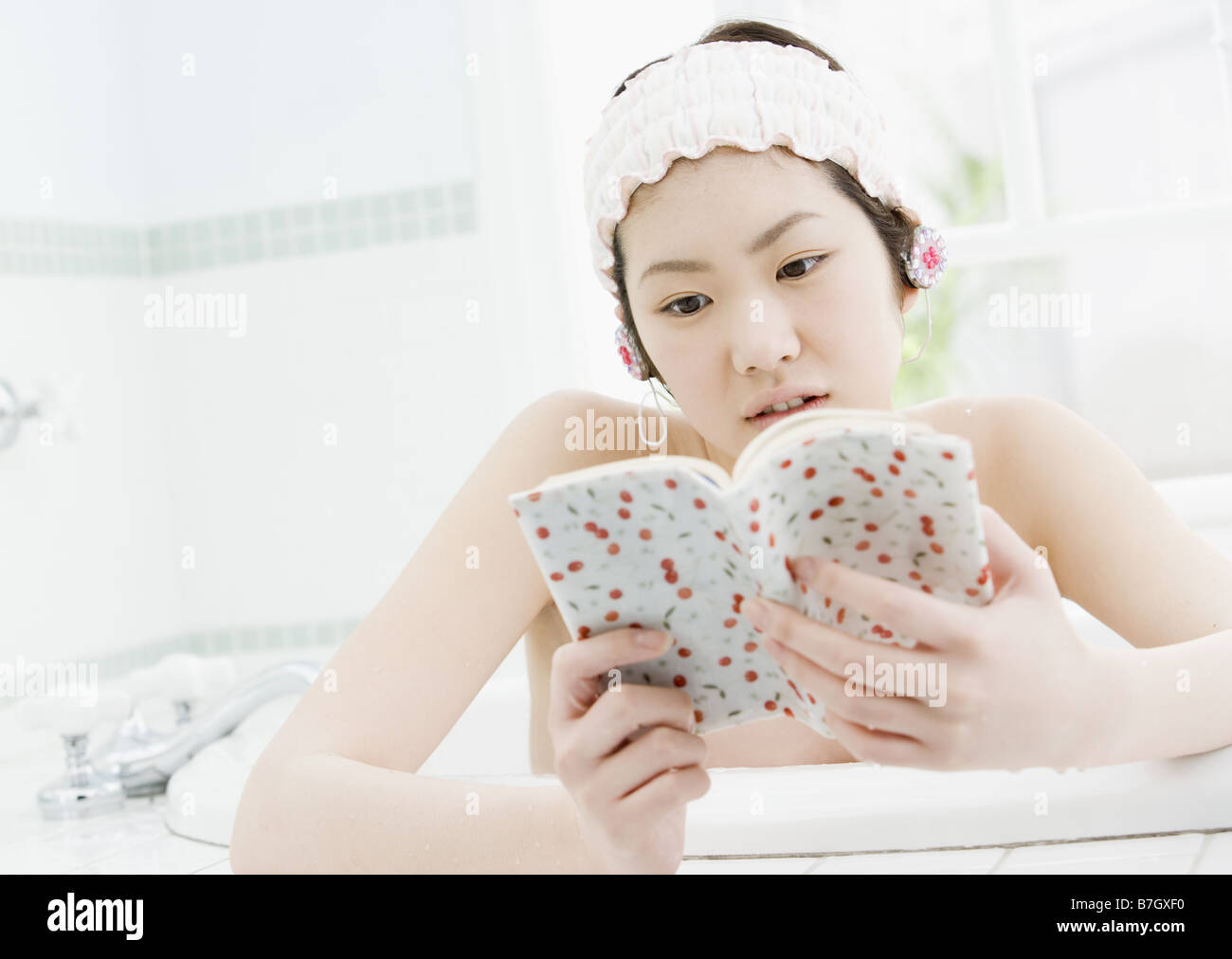Woman Reading a Book in Bathtub Stock Photo - Alamy