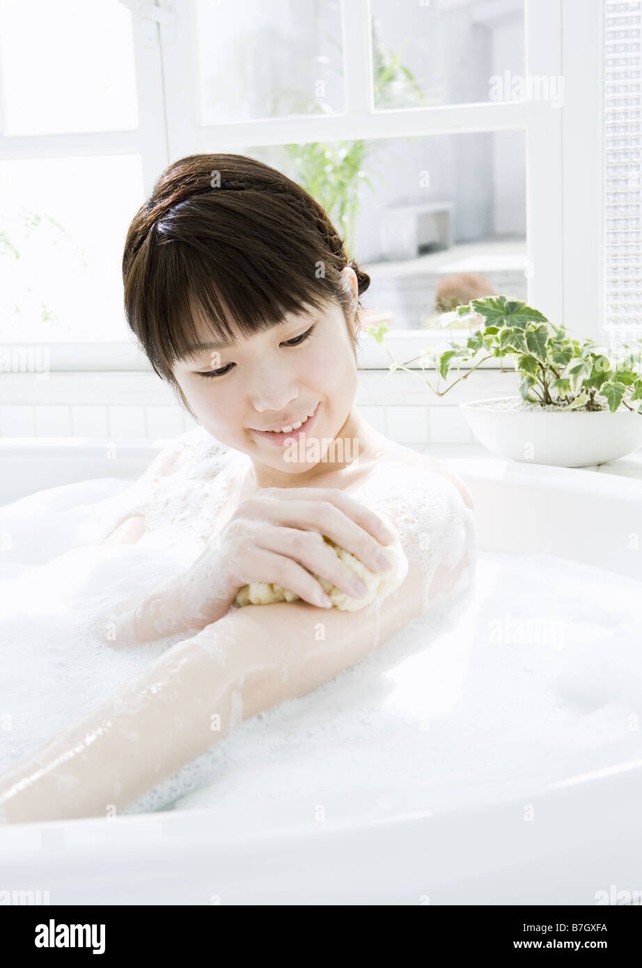 Woman taking a bubble bath hi-res stock photography and images - Alamy