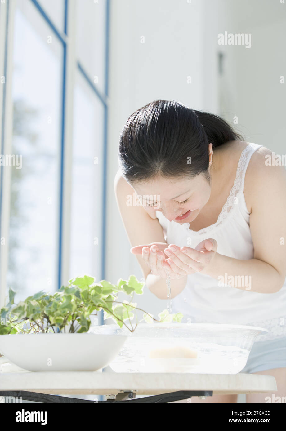 Woman Washing her Face in Sink Stock Photo - Alamy