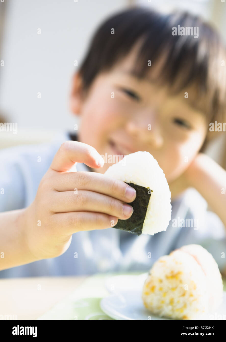 Hand holding rice ball hi-res stock photography and images - Alamy