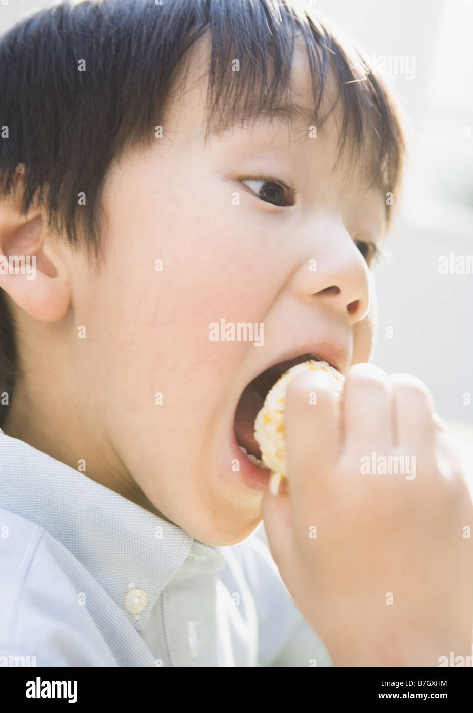 Boy eating rice ball hi-res stock photography and images - Alamy