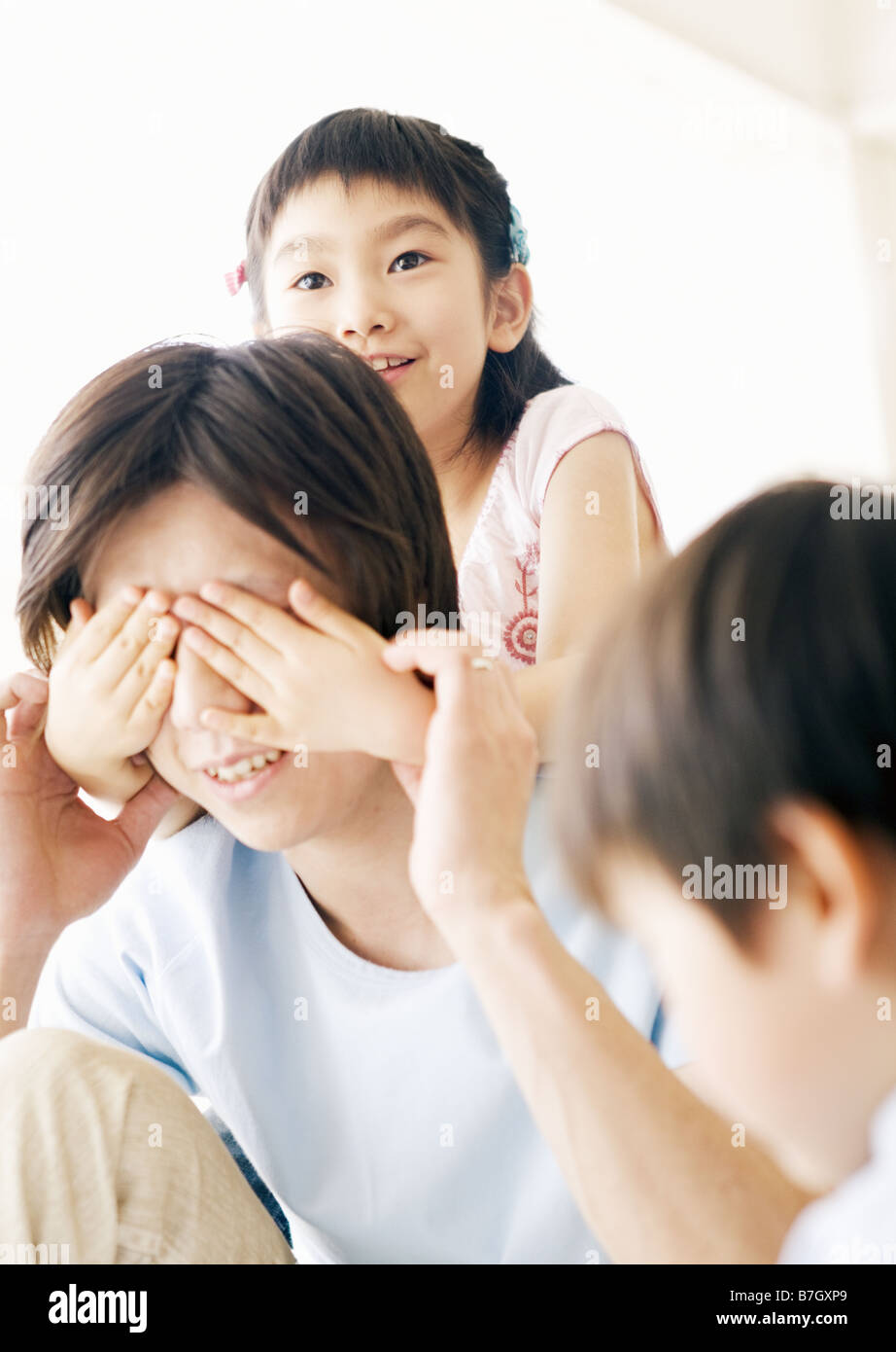 Daughter Covering Father's Eyes Stock Photo - Alamy