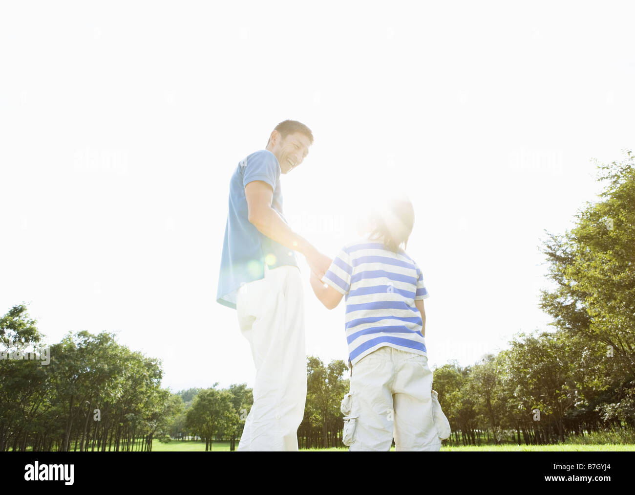 Father and son holding hands Stock Photo - Alamy