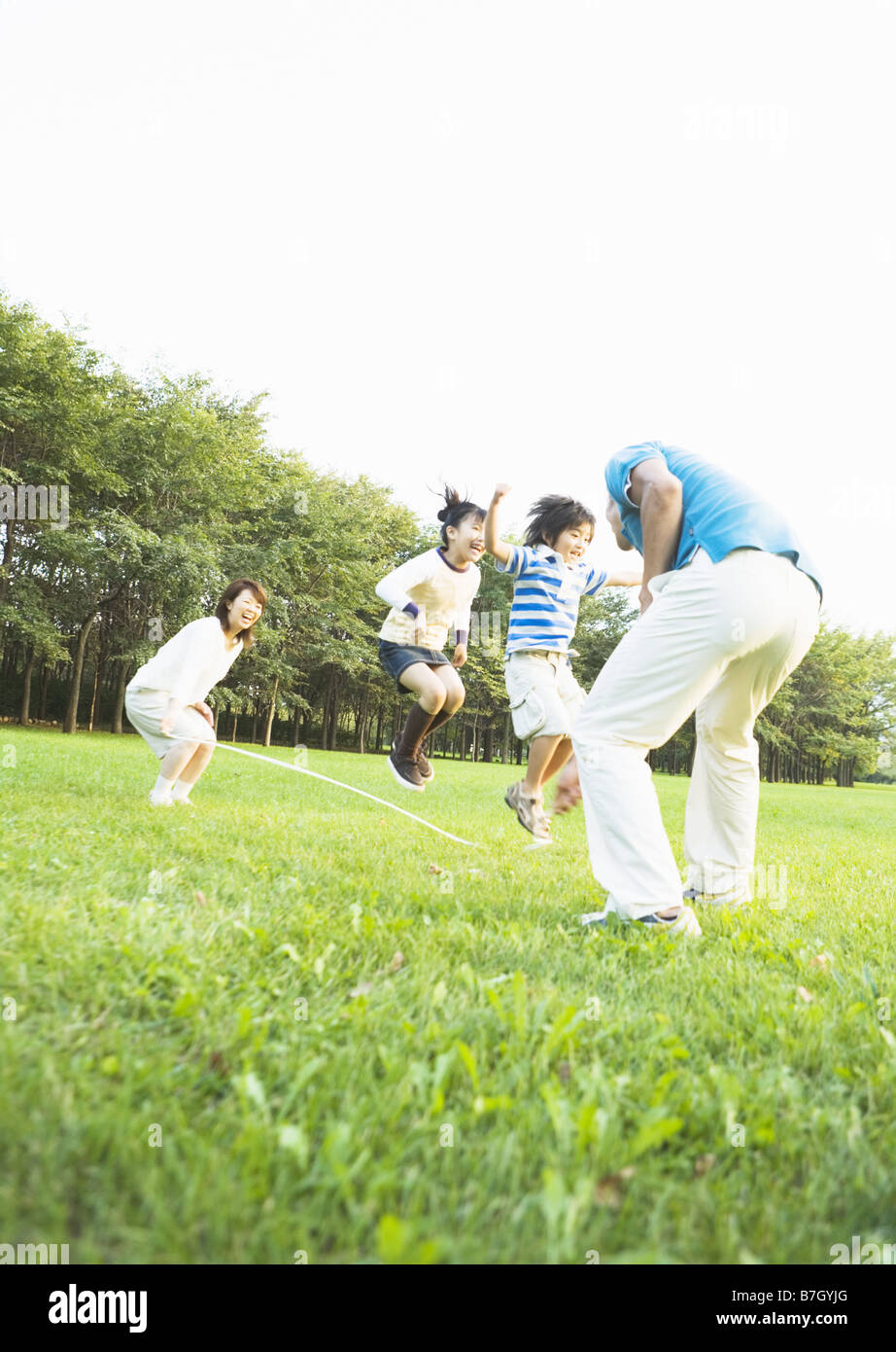 Family jumping rope Stock Photo - Alamy