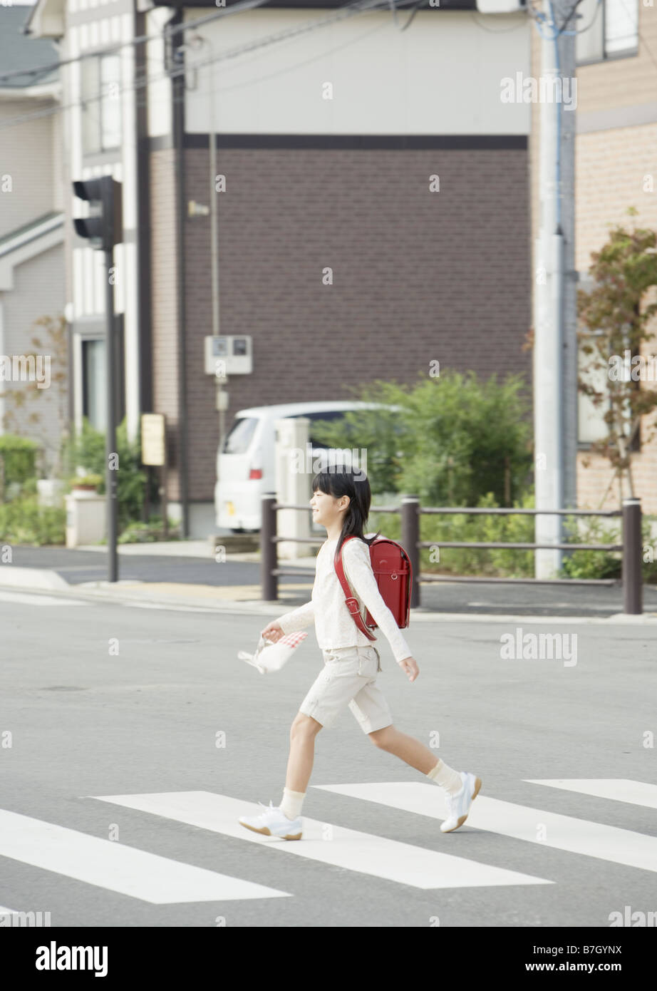 A girl walking on the pedestrian crossing Stock Photo - Alamy