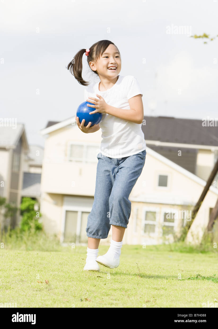 A girl playing with a ball Stock Photo - Alamy