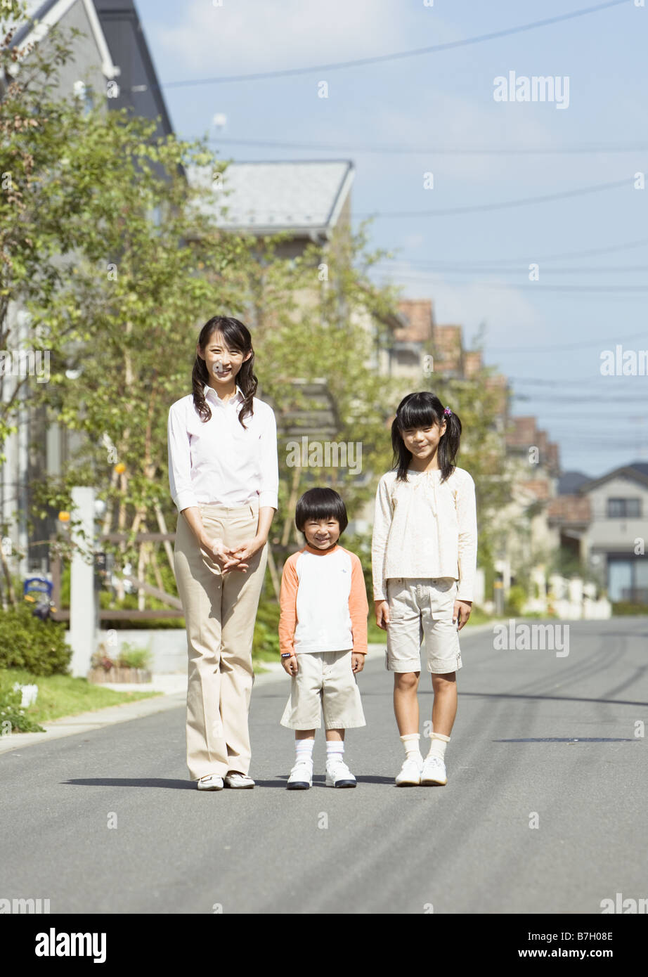 Mother and children standing in a line Stock Photo - Alamy