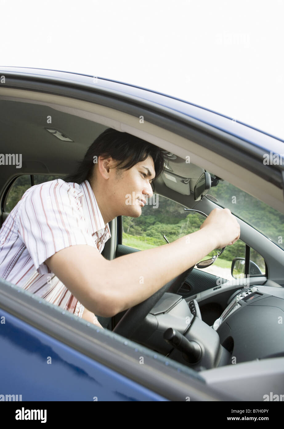A young man driving a car Stock Photo - Alamy