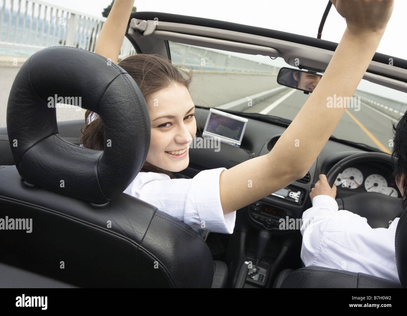 Couple driving a convertible Stock Photo - Alamy