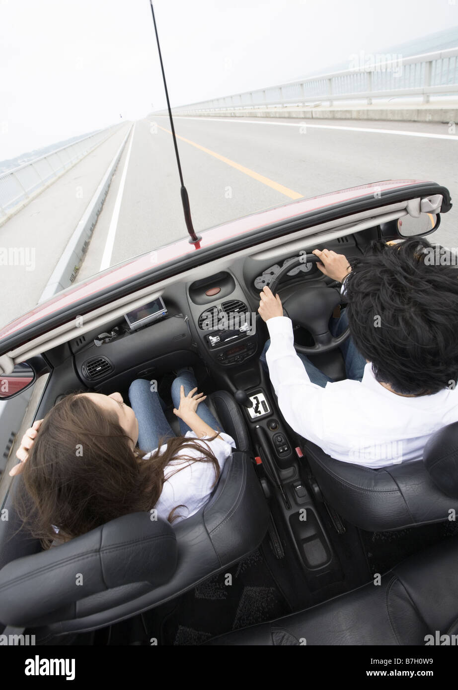 Couple driving a convertible Stock Photo - Alamy
