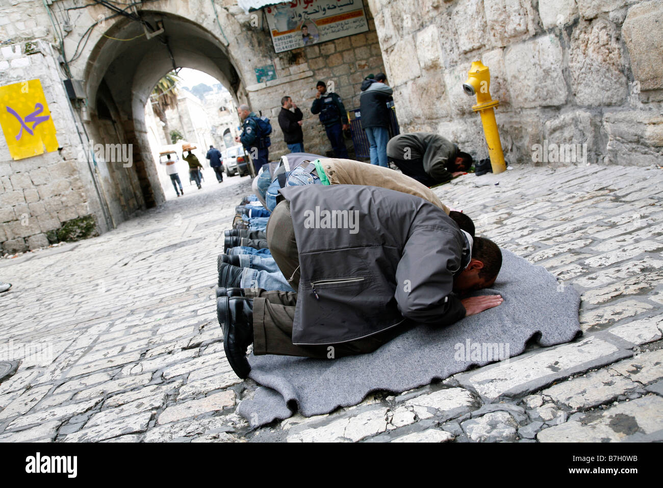 Palestinian Muslims praying outside the Al Aqsa mosque compound in the ...