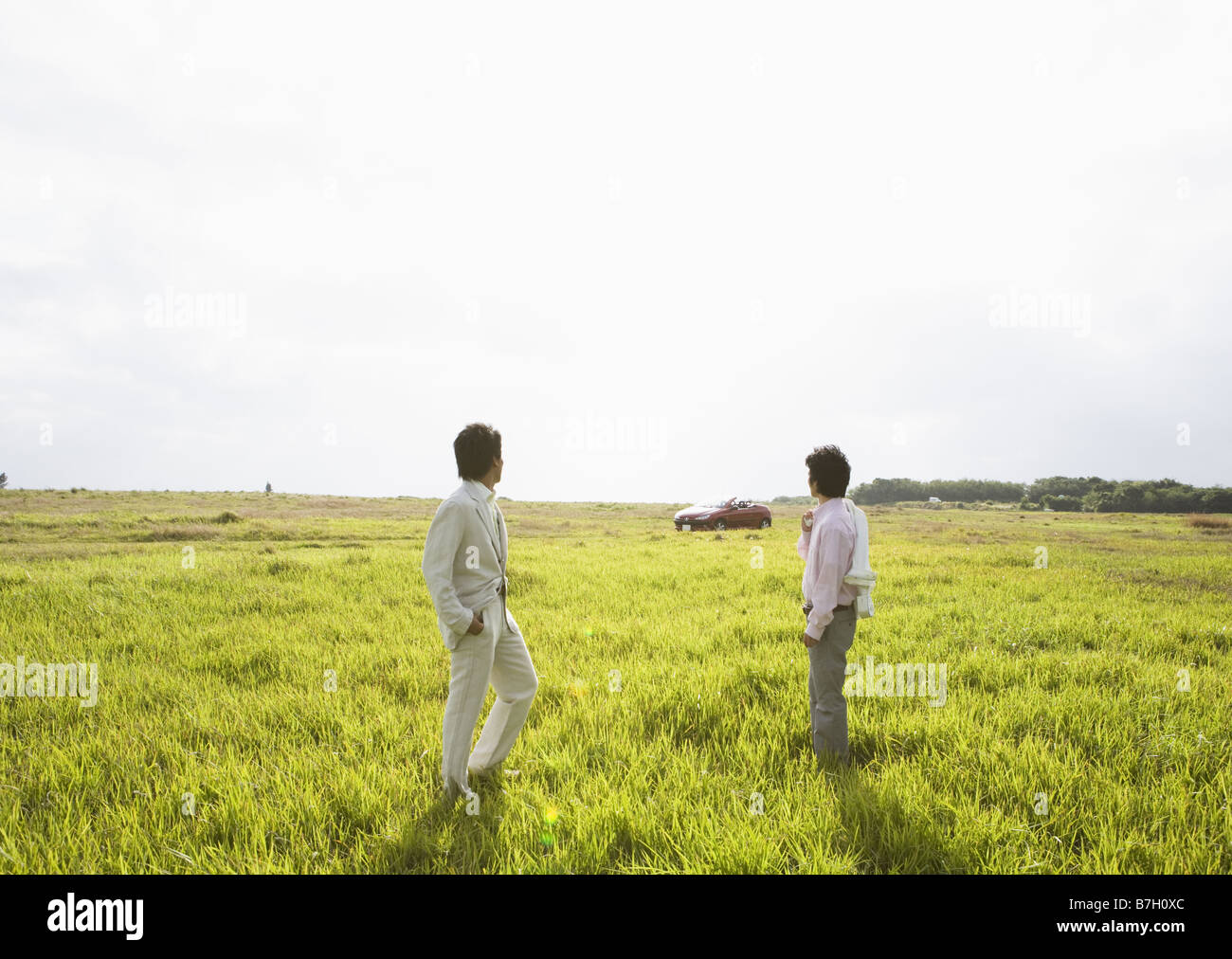 Two men in a field of grass Stock Photo - Alamy