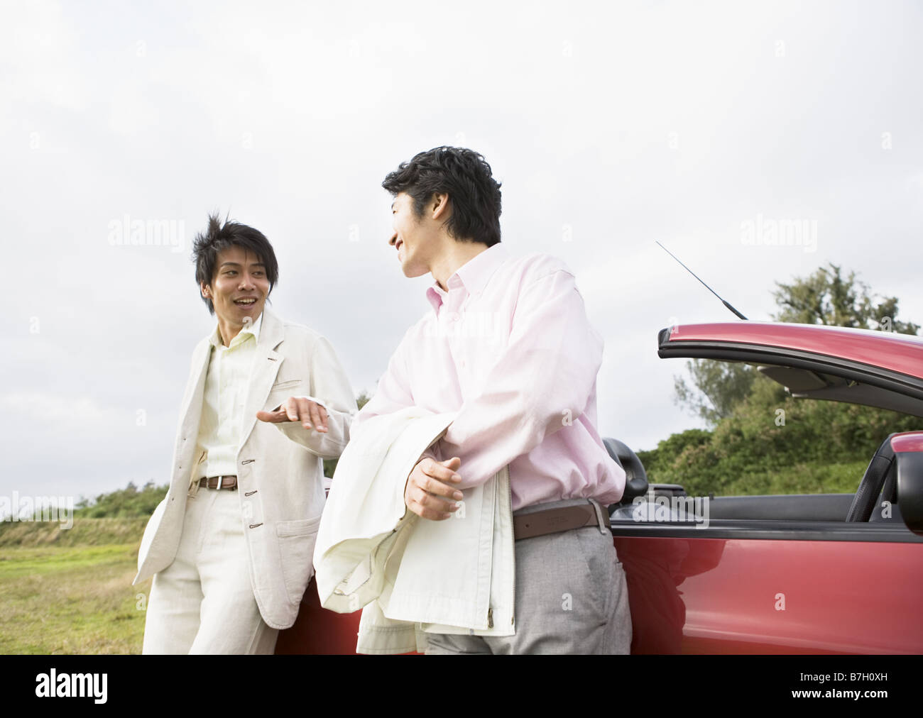 Two men with a convertible Stock Photo - Alamy