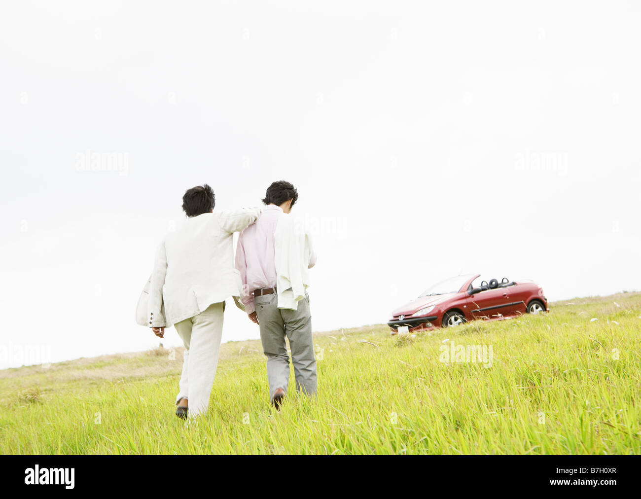 Two men in a field of grass Stock Photo - Alamy