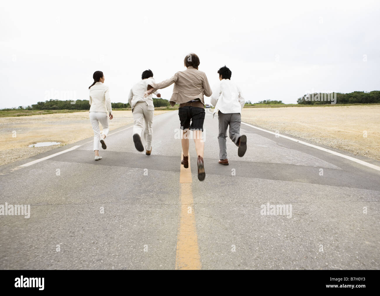 Young people running a street Stock Photo - Alamy