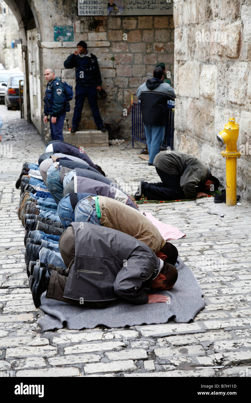 Palestinian Muslims praying outside the Al Aqsa mosque compound in the ...