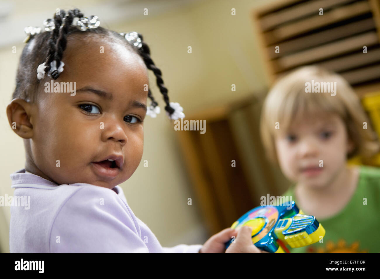 Girl playing with boys toys hi-res stock photography and images - Alamy