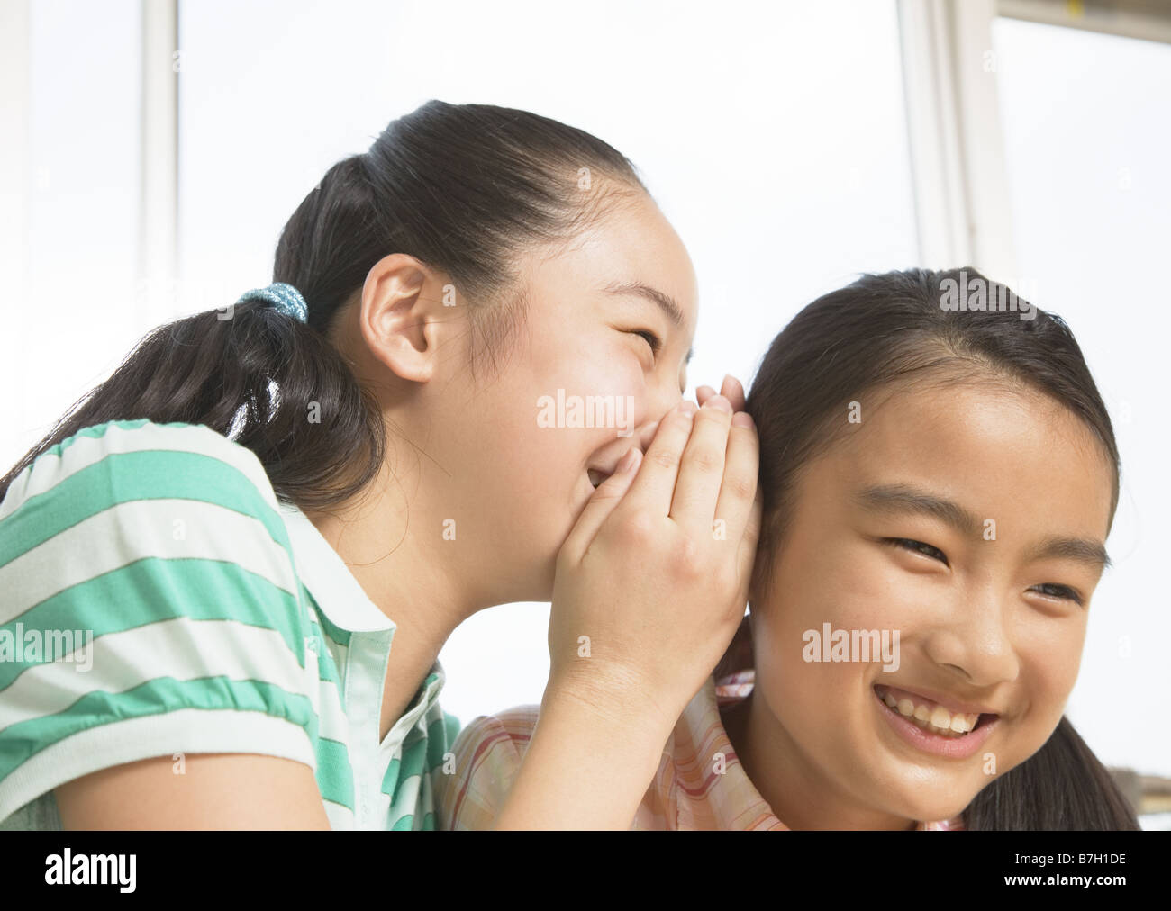 Girls children whispering secret hi-res stock photography and images ...