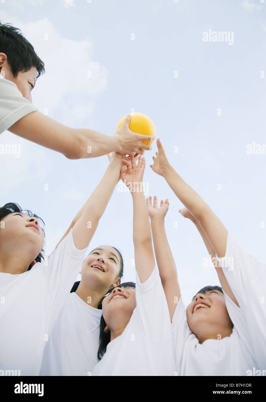 Elementary school students catching a ball Stock Photo - Alamy