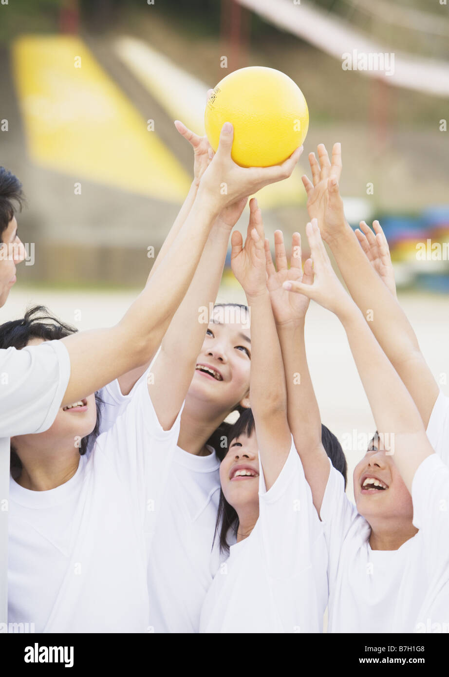 Elementary students catching a ball Stock Photo - Alamy