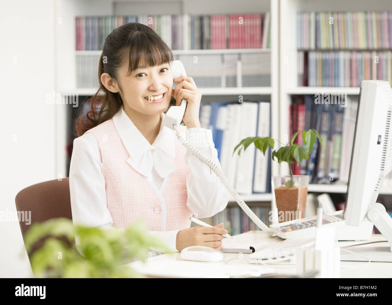 An office worker making a call Stock Photo - Alamy