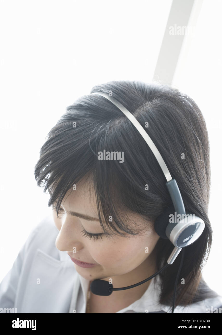 Operator wearing a headphone in the office Stock Photo - Alamy