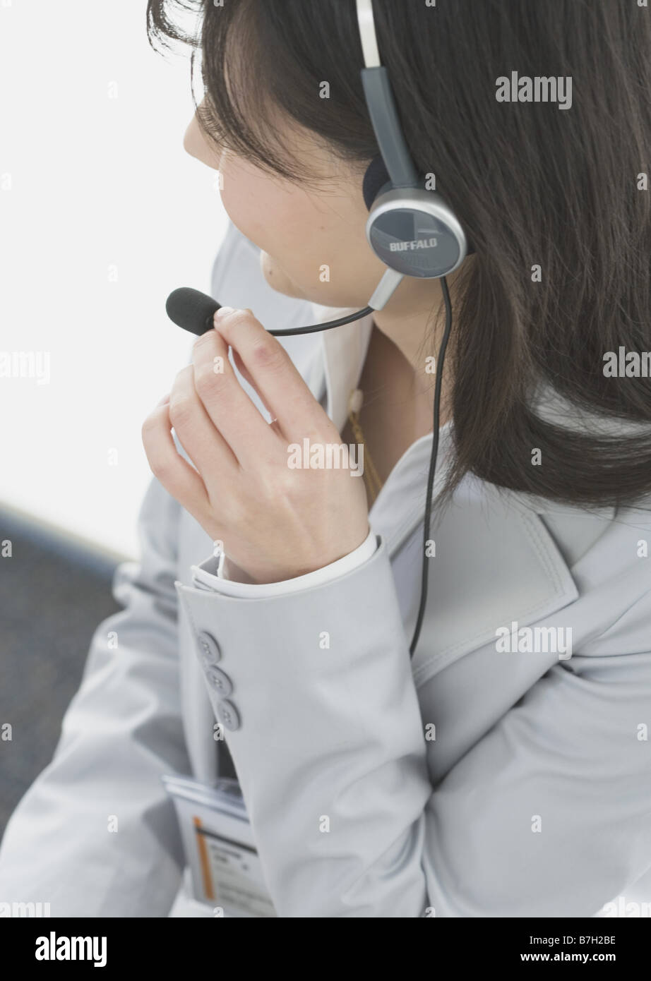 Operator wearing a headphone in the office Stock Photo - Alamy