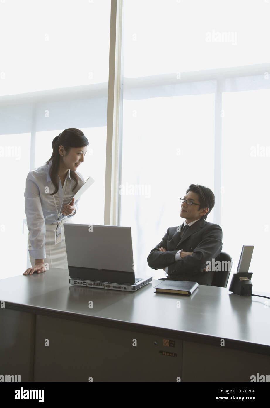 Businessmen having a conversation in the office Stock Photo - Alamy