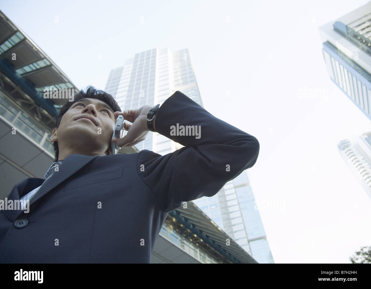Man talking on phone outside of building Stock Photo - Alamy