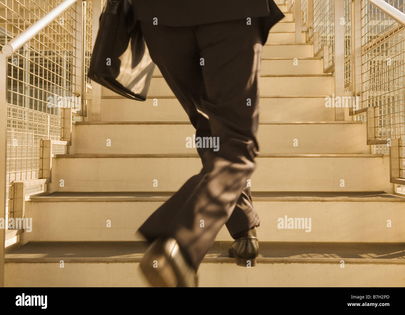 Businessman running up stairs Stock Photo - Alamy