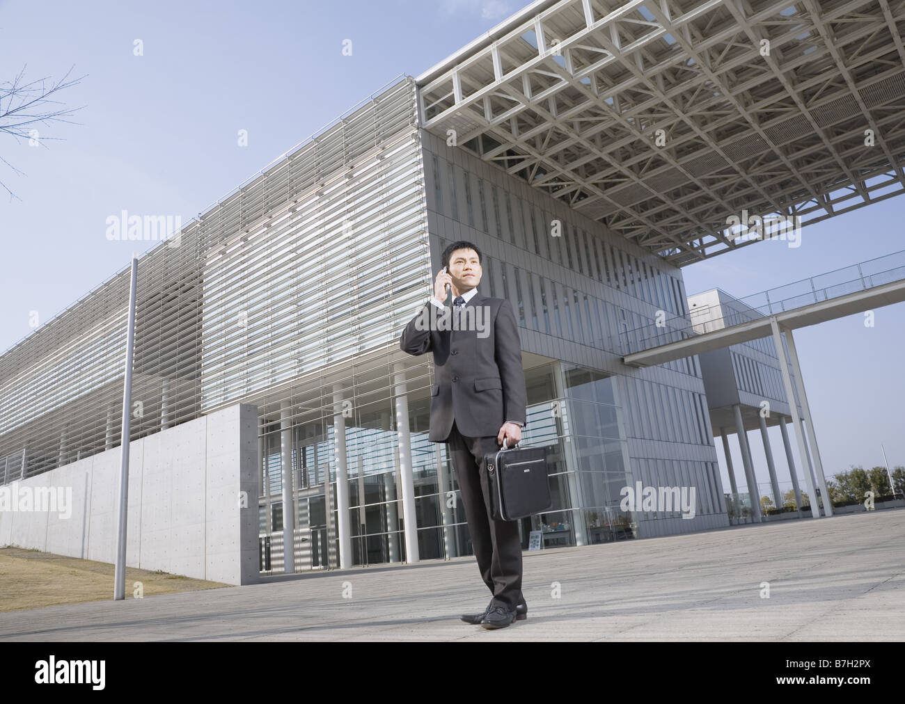Businessman standing tall building talking hi-res stock photography and ...