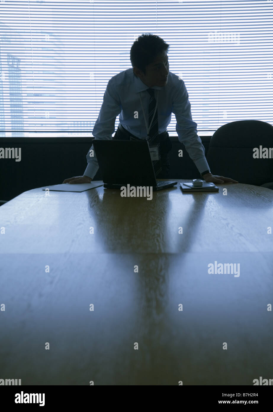 Businessman at table in conference room Stock Photo - Alamy