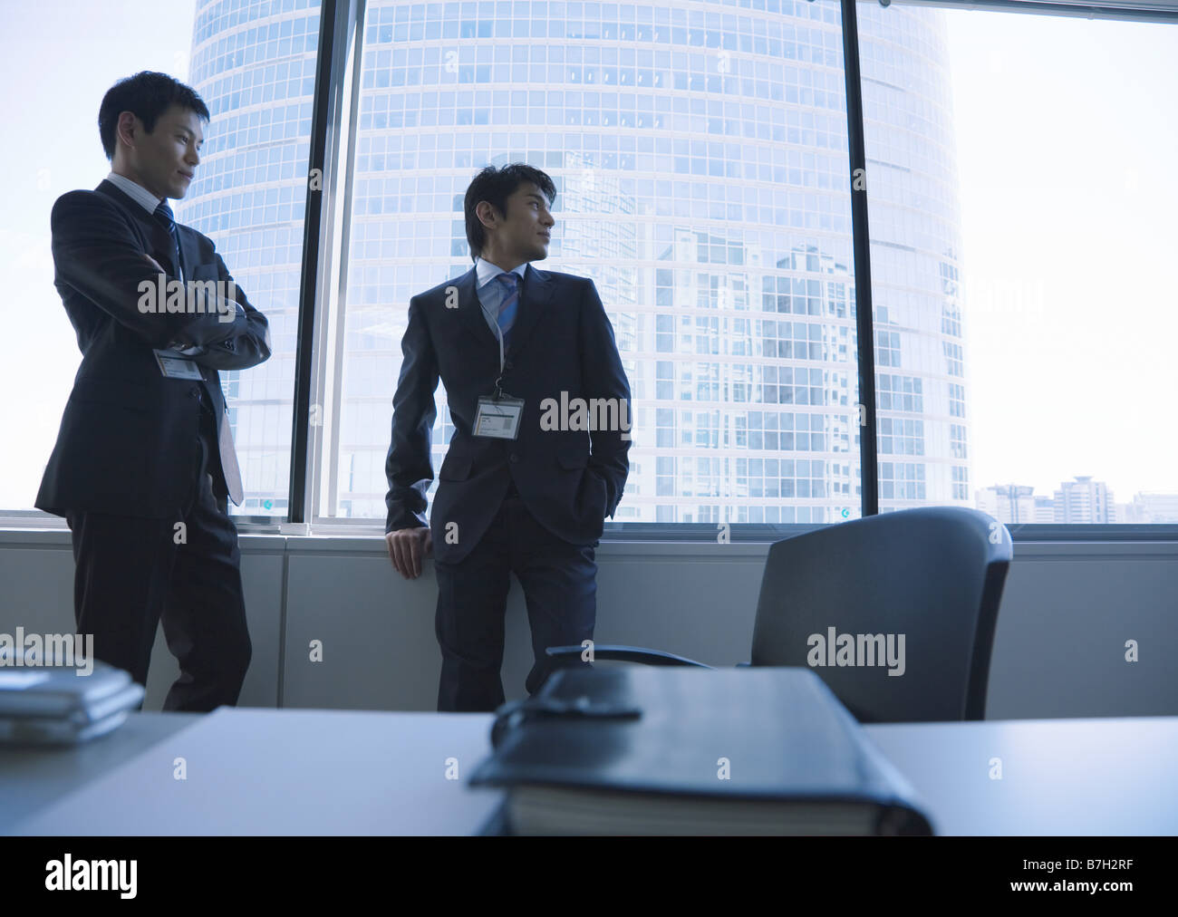 Businessmen in office room Stock Photo - Alamy