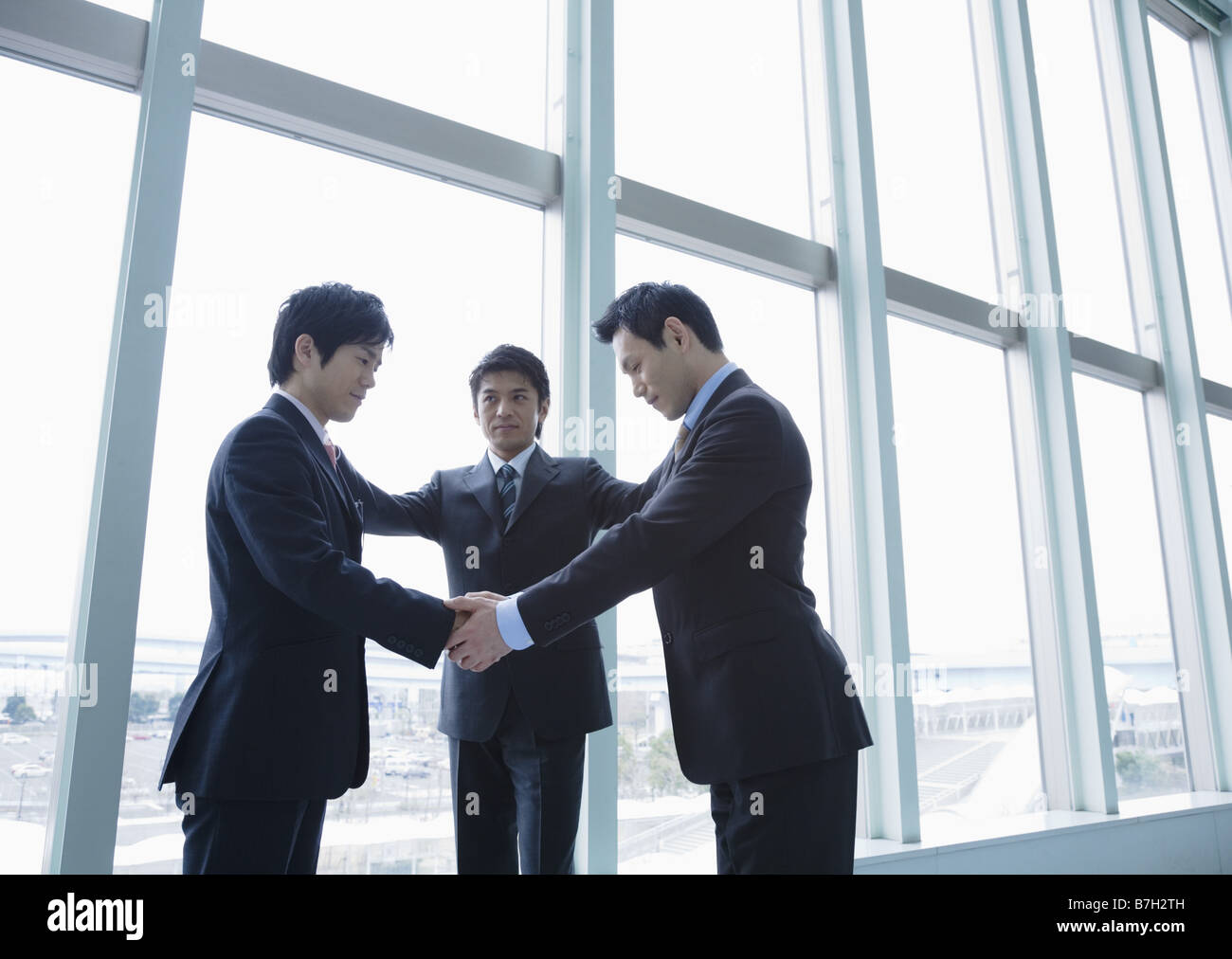 Businessmen shaking hands Stock Photo - Alamy