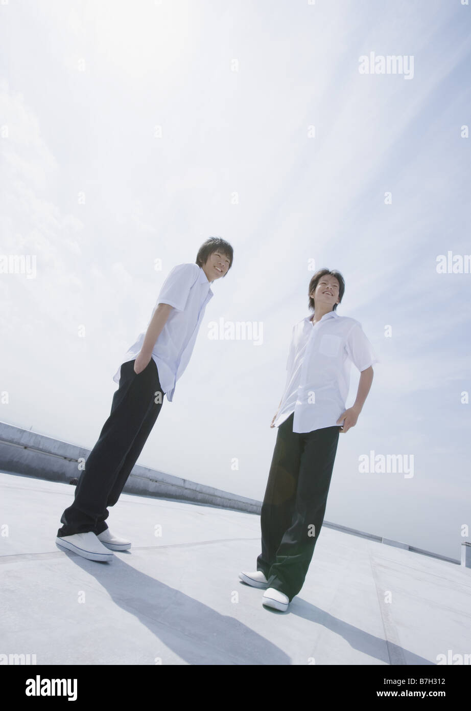 Boys in school uniform standing on rooftop Stock Photo - Alamy