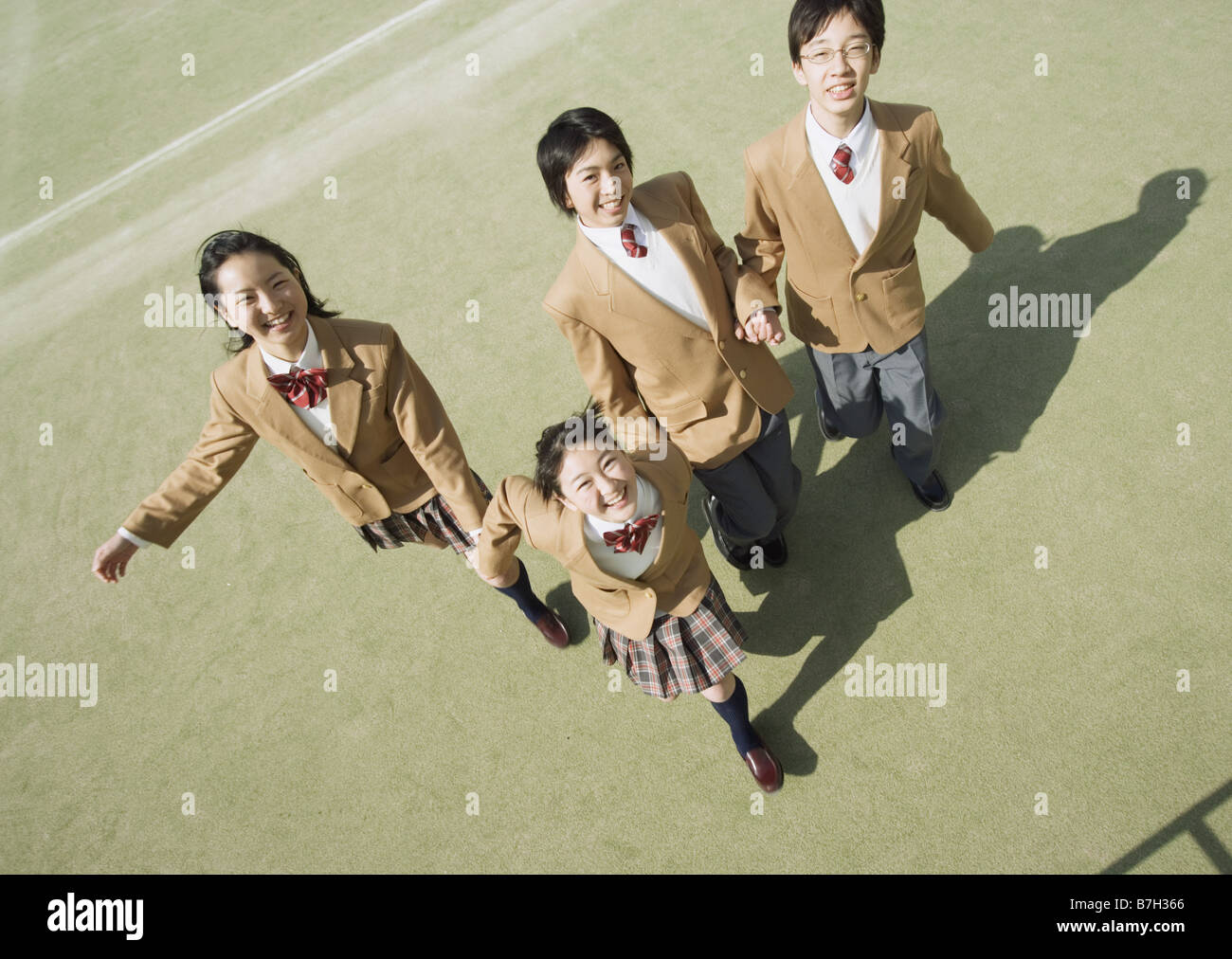 Group of students running in athletic field Stock Photo - Alamy