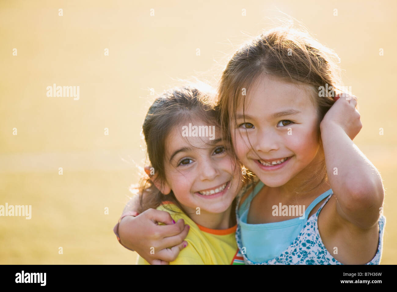 Smiling friends hugging Stock Photo - Alamy