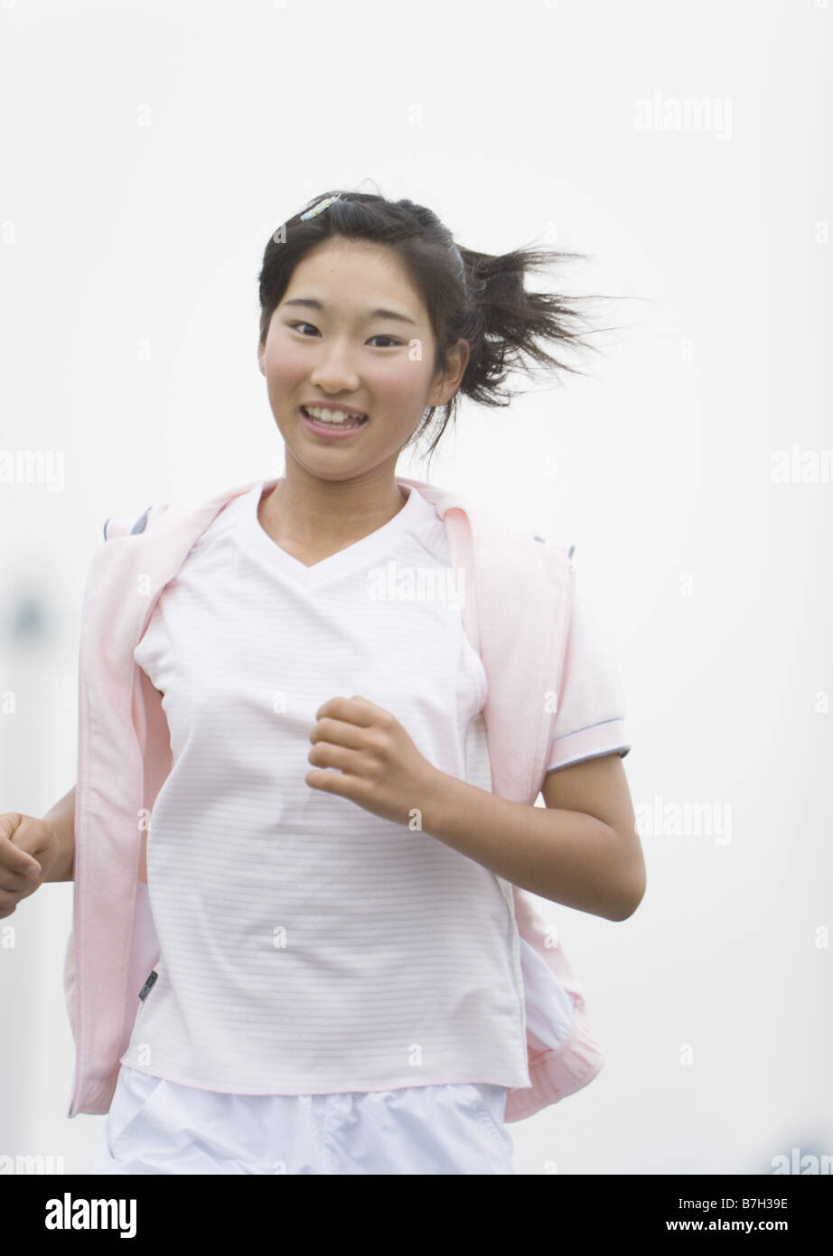 Running girl with a ponytail Stock Photo - Alamy