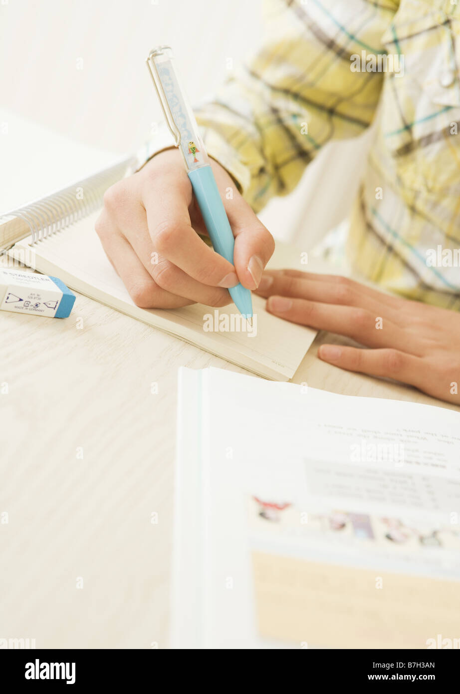 Girl doing homework at the desk Stock Photo - Alamy