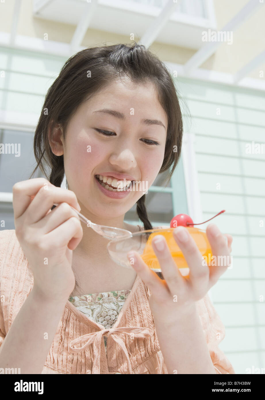 Girl eating jelly outside Stock Photo - Alamy