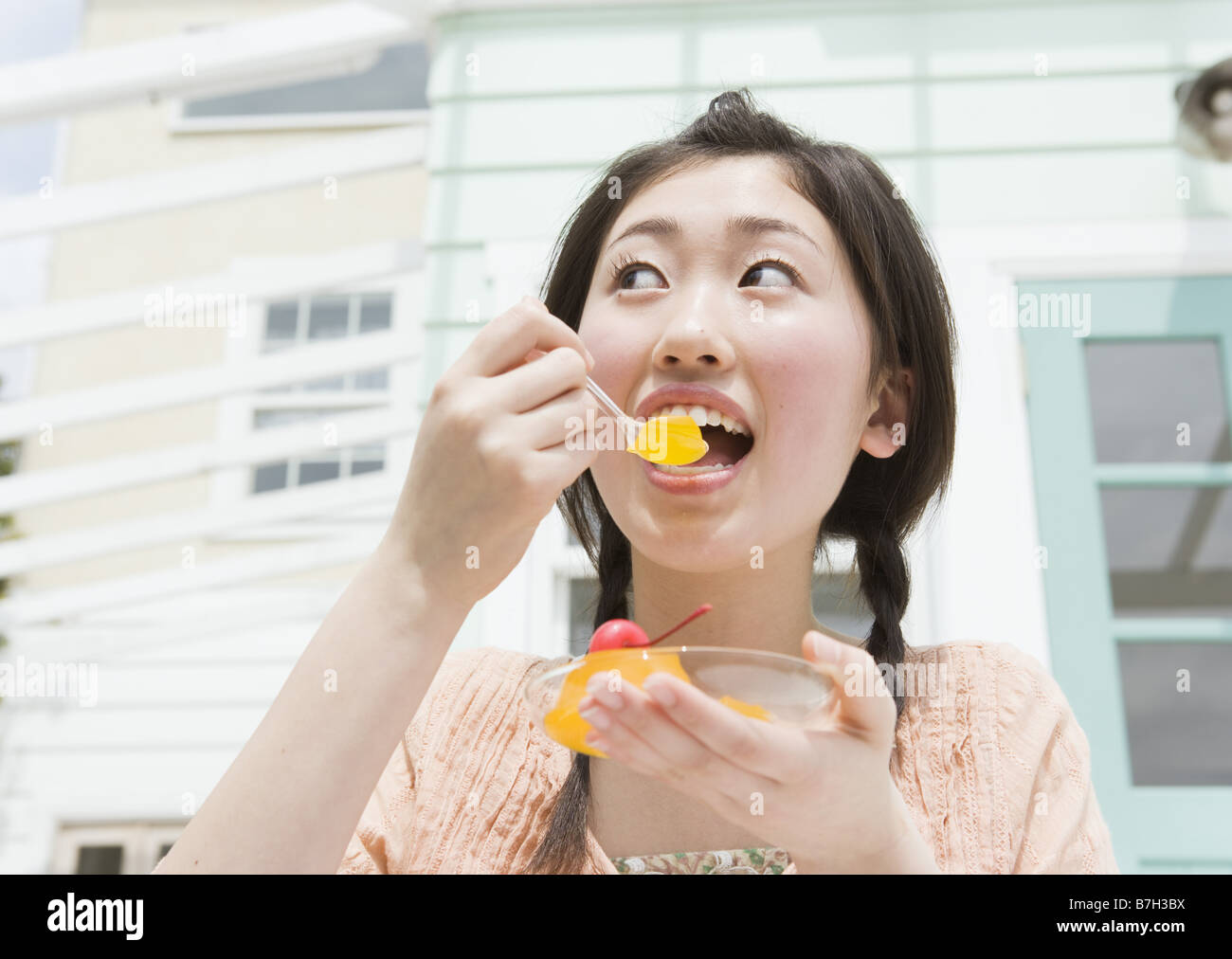 Girl eating jelly outside Stock Photo - Alamy