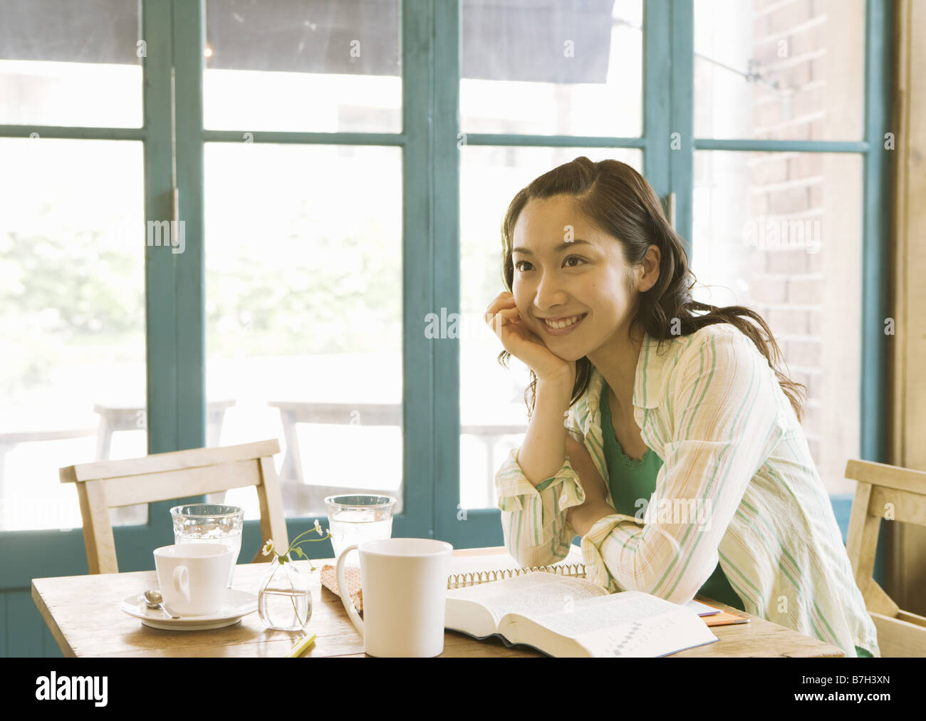 Girl sitting beside window Stock Photo - Alamy