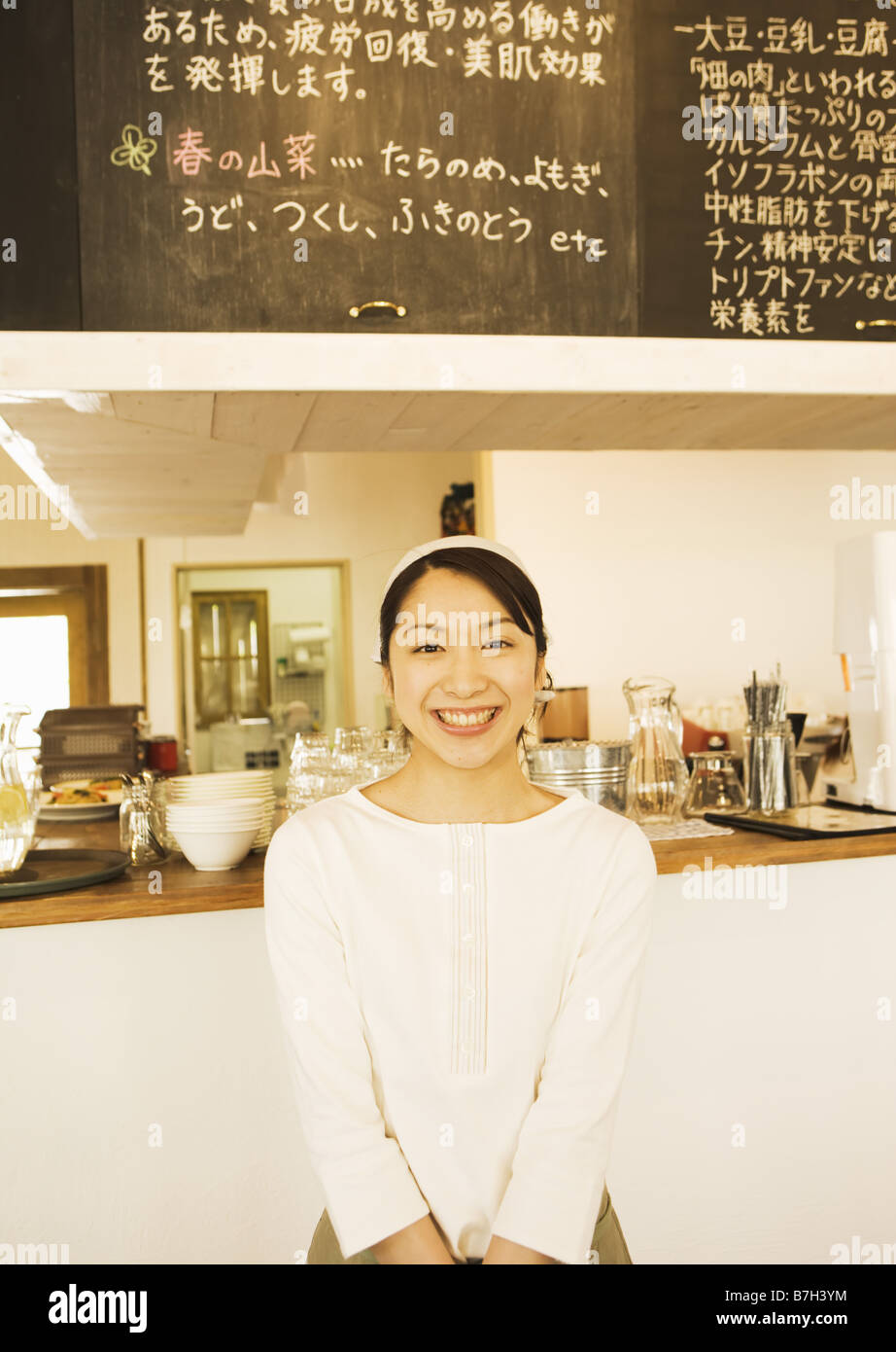 Smiling waitress wearing uniform Stock Photo - Alamy