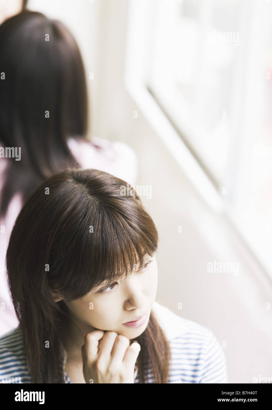 Pensive young woman Stock Photo - Alamy