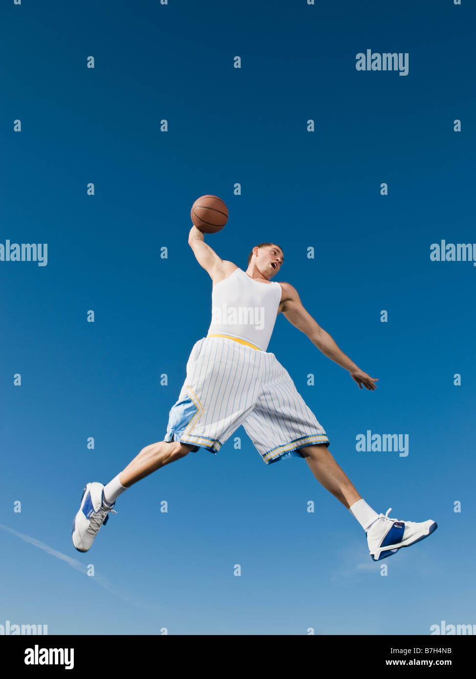 African man playing basketball in mid-air Stock Photo - Alamy