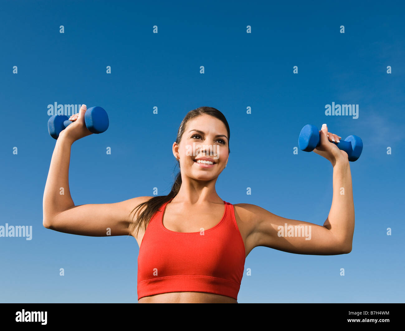 Native American woman lifting hand weights Stock Photo - Alamy