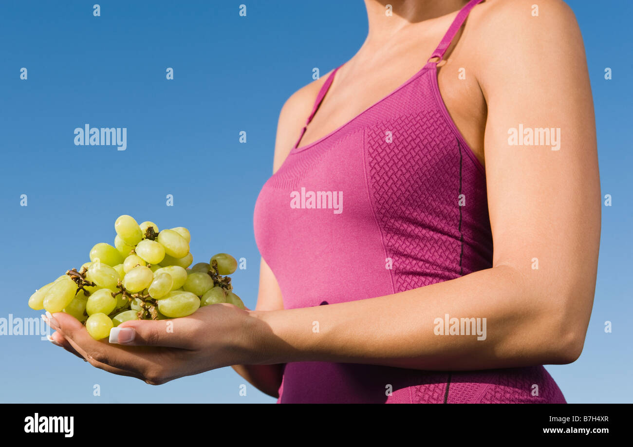 Native American holding a bunch of grapes Stock Photo - Alamy