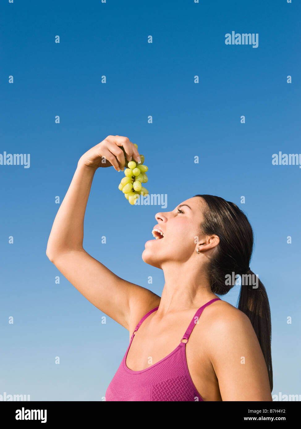 Native American eating grapes Stock Photo - Alamy