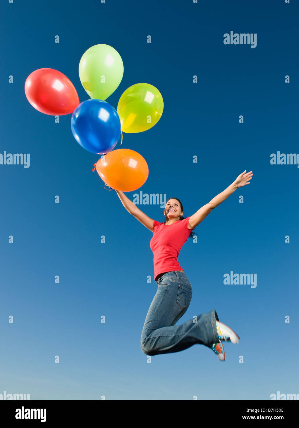 Native American holding balloons in mid-air Stock Photo - Alamy