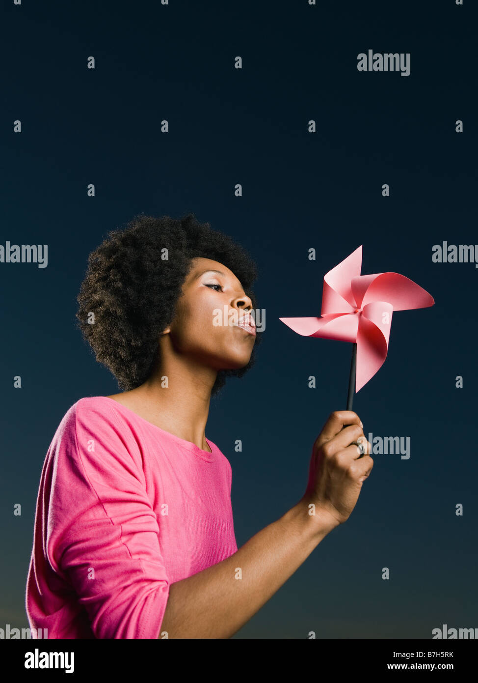 African woman blowing pinwheel Stock Photo - Alamy